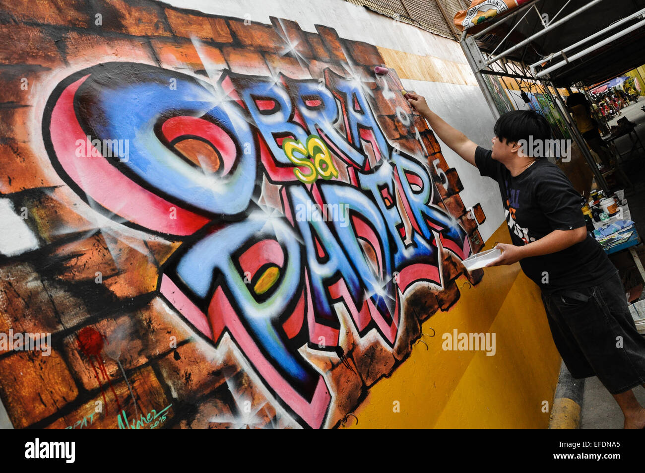 An artist apply finishing touches in his mural painting during the Obra ...