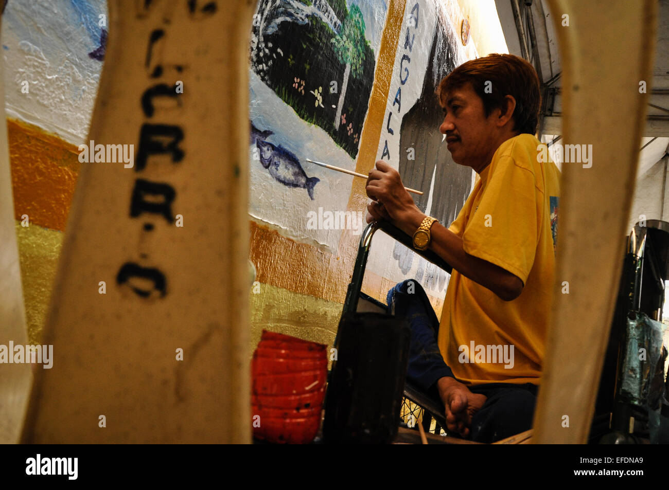 A PWD artist paints a mural as he participates during the Obra sa Pader ...