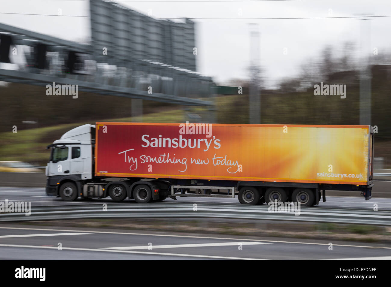 A Sainsbury's branded articulated lorry heading westbound on the M25 ...