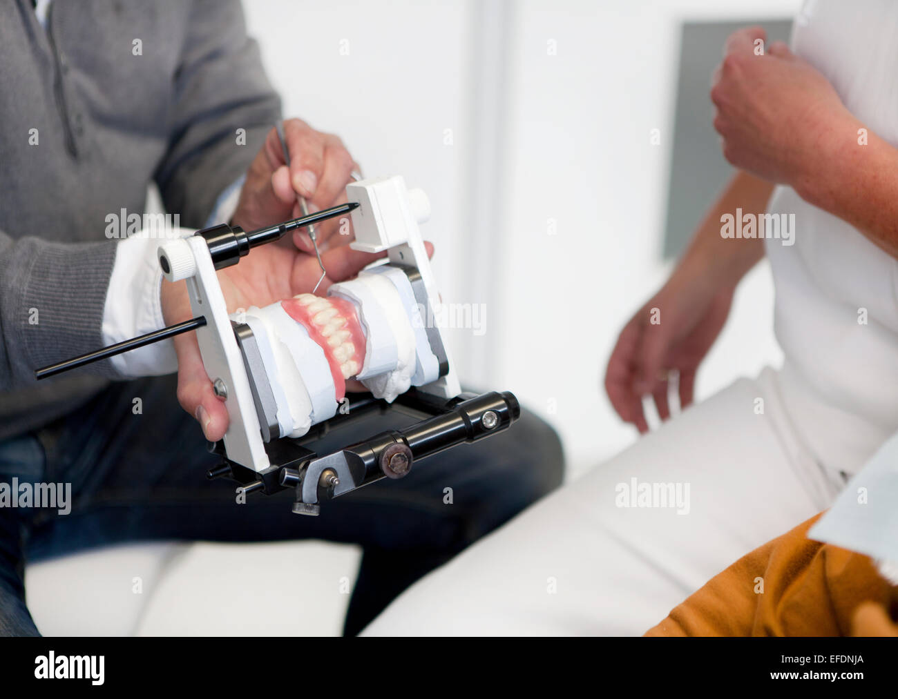 a dentist showing his patient denture, no face Stock Photo - Alamy