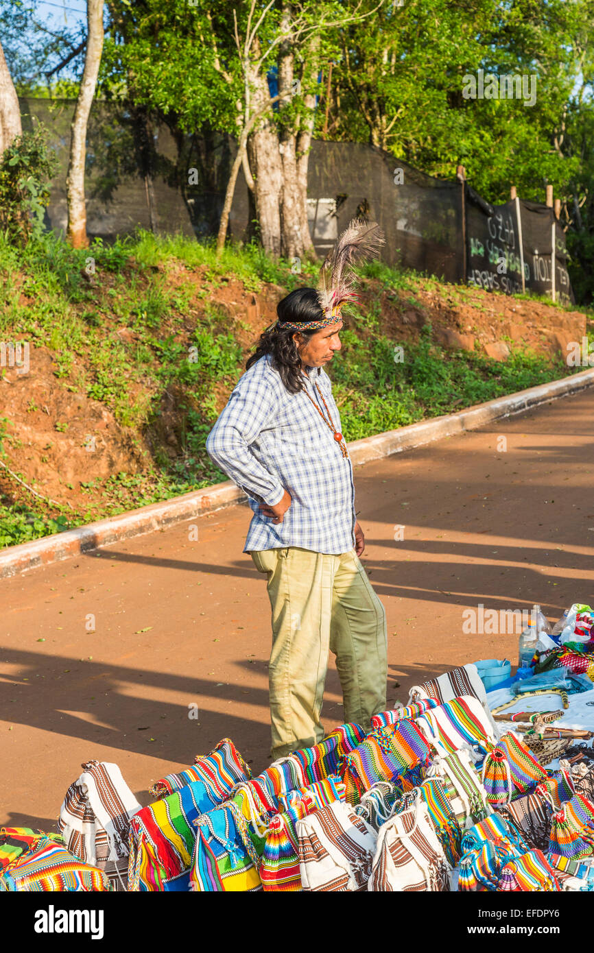 Argentinian street trader with feathered headband selling roadside ...