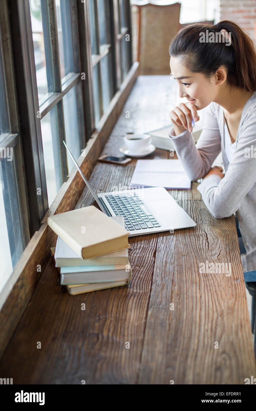 Young woman studying in cafe Stock Photo - Alamy