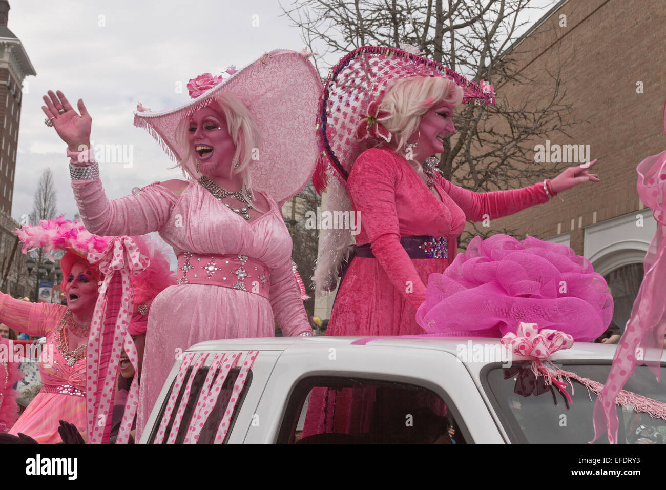 Frilly ladies dressed all in pink with pink skin, one with a beard ...