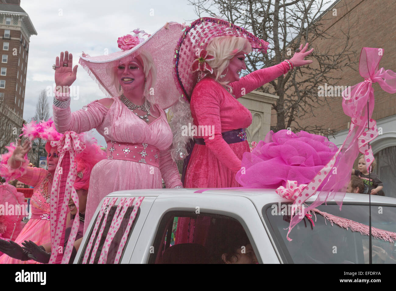 Frilly ladies dressed all in pink with pink skin, one with a beard ...