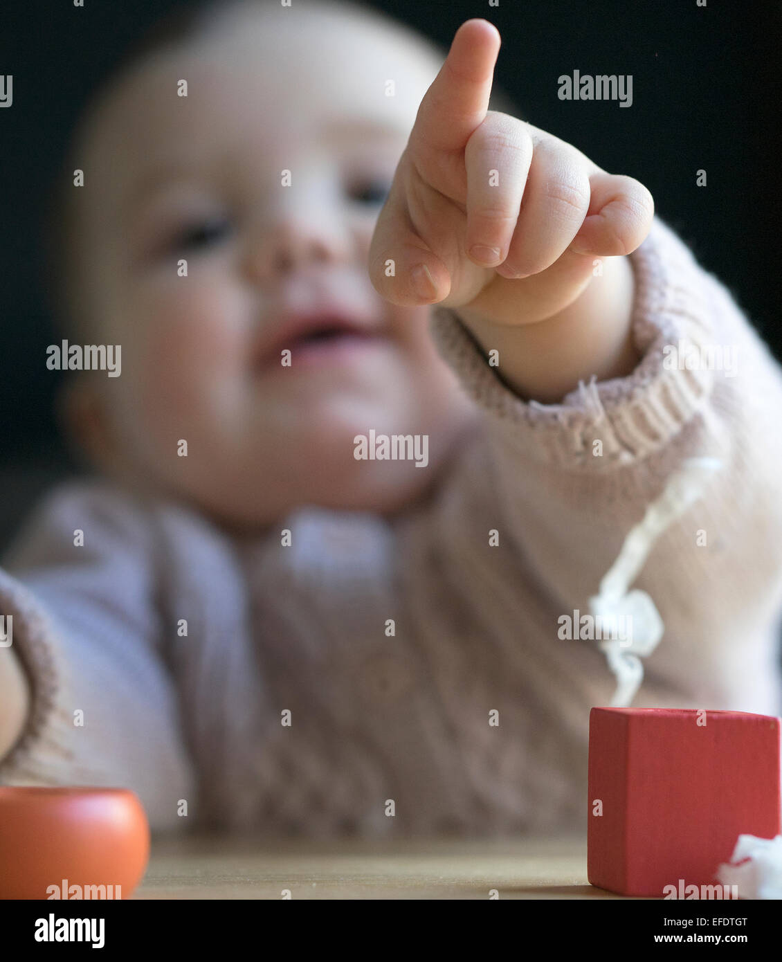 A ten month old baby girl pointing. Photo Tim Clayton Stock Photo - Alamy