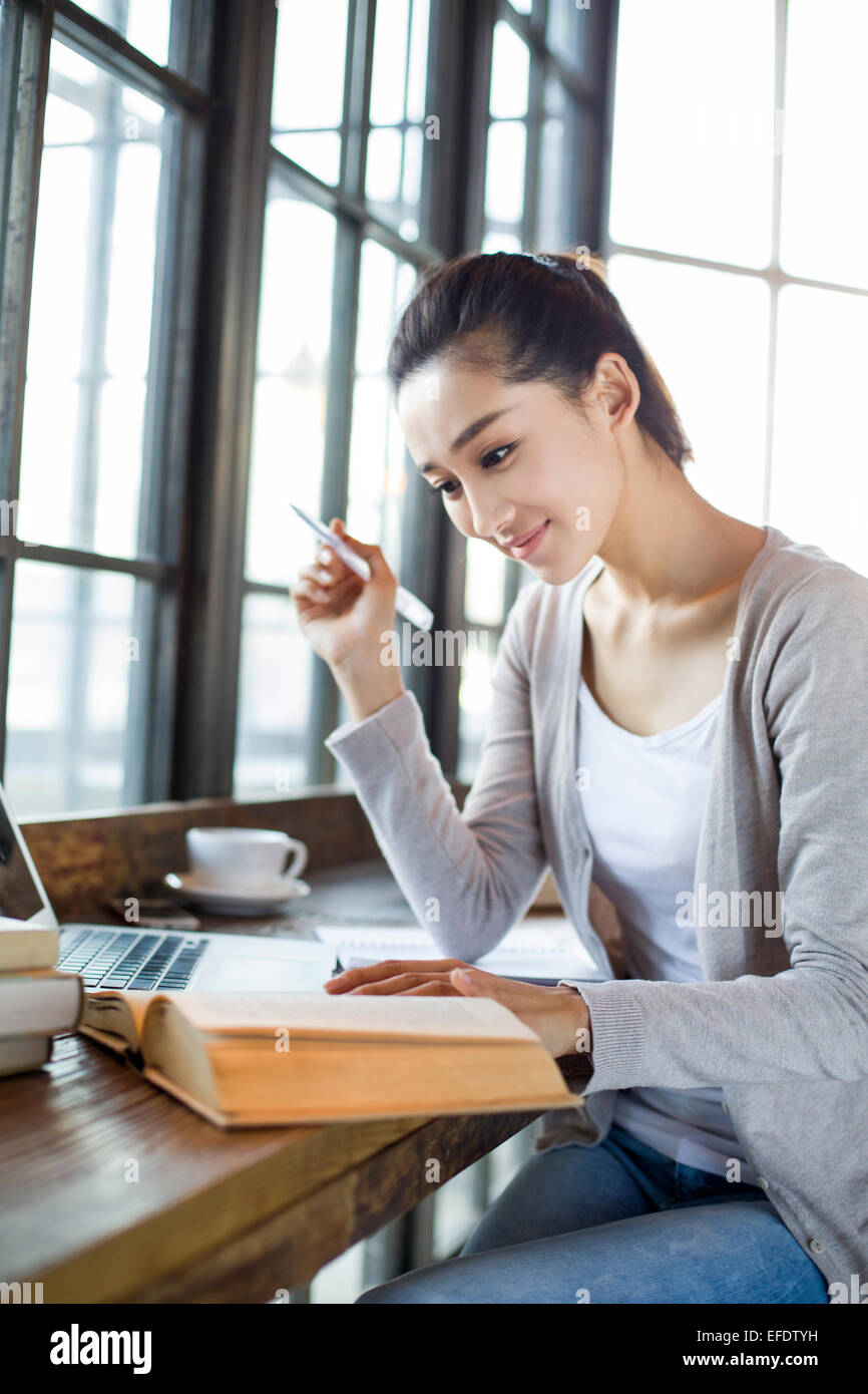 Young woman studying in cafe Stock Photo - Alamy