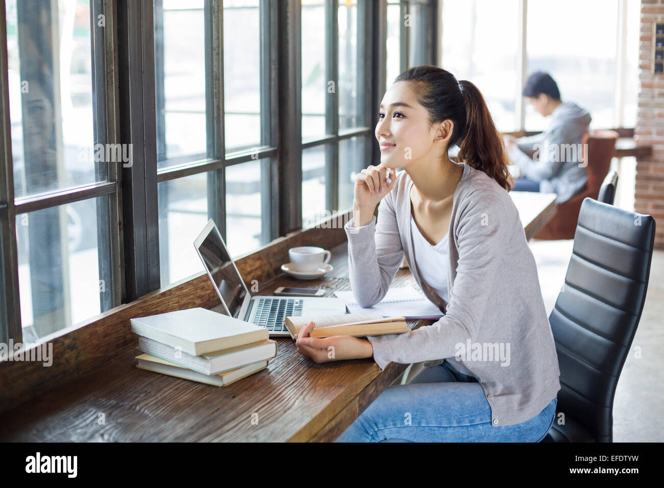 Young woman studying in cafe Stock Photo - Alamy