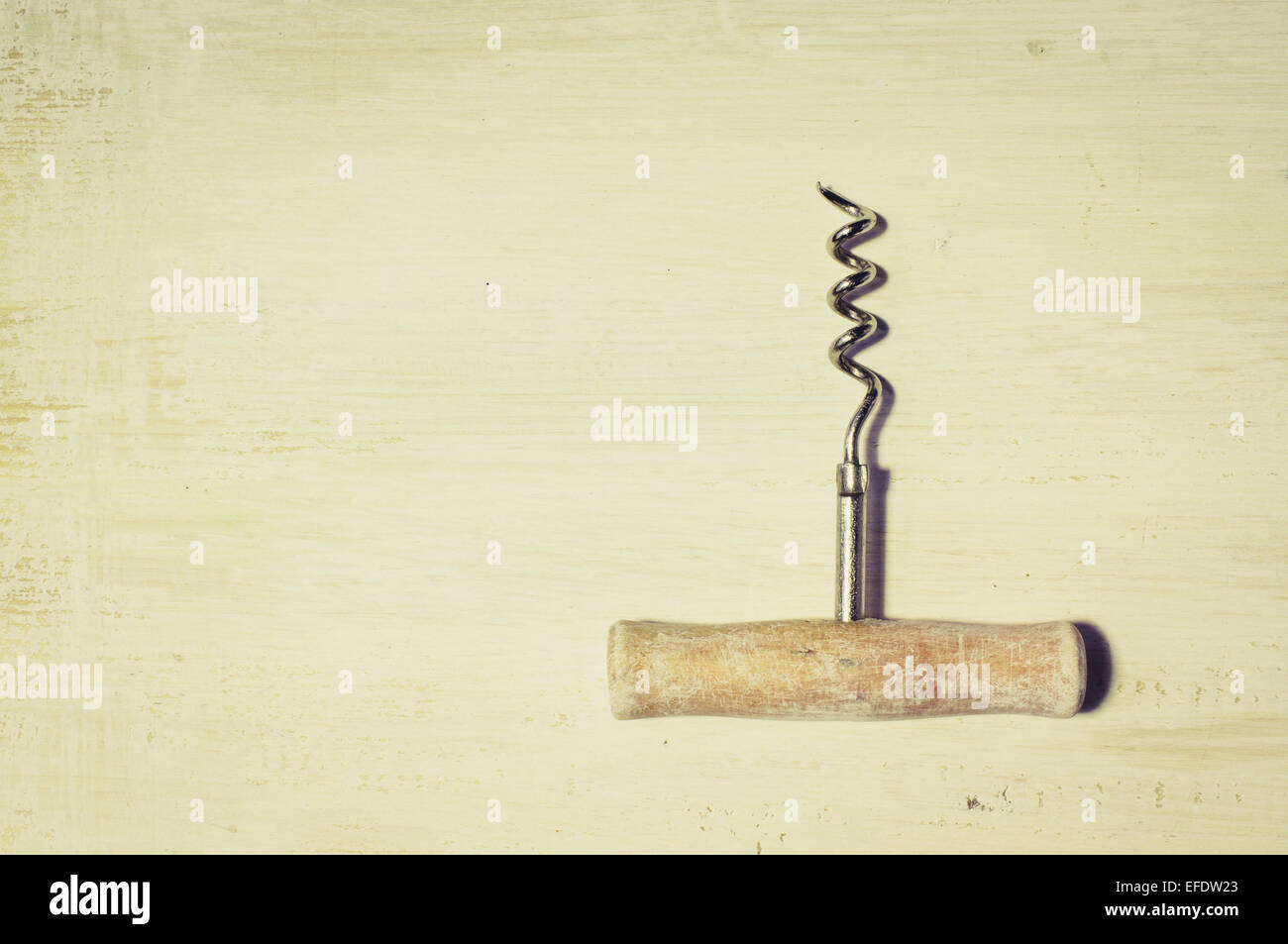 Vintage corkscrew on the old board for background Stock Photo - Alamy