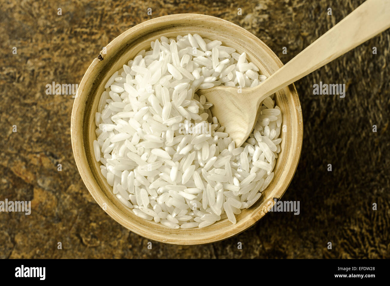 Long grain rice in a wooden bowl, top view Stock Photo - Alamy
