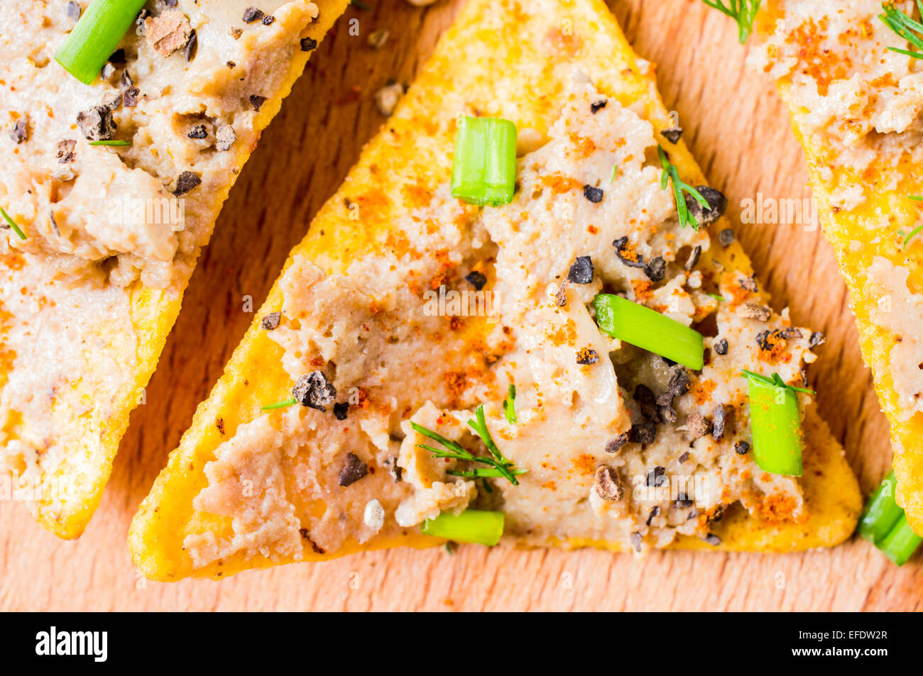 Tapas. Chips, tacos with meat paste, herbs and spices Stock Photo - Alamy