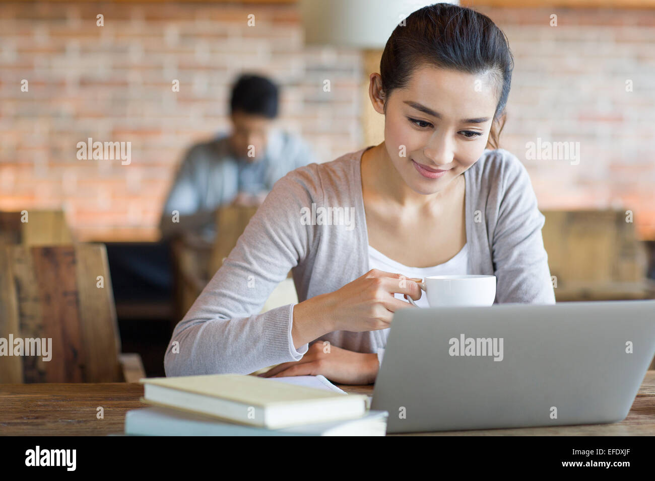 Young woman studying in cafe Stock Photo - Alamy