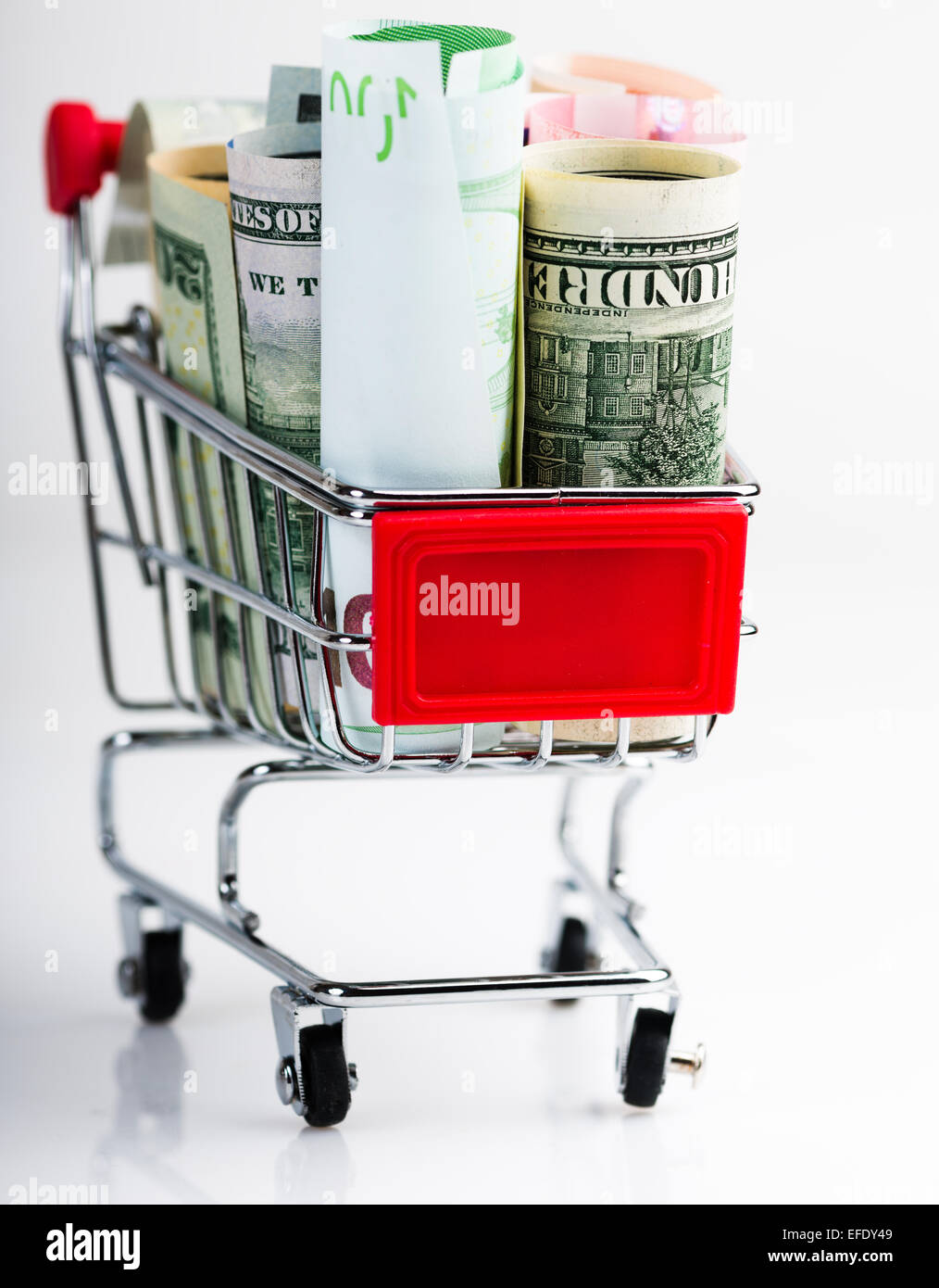 Shopping cart full of money (dollar, euro) isolated on white. Multi ...