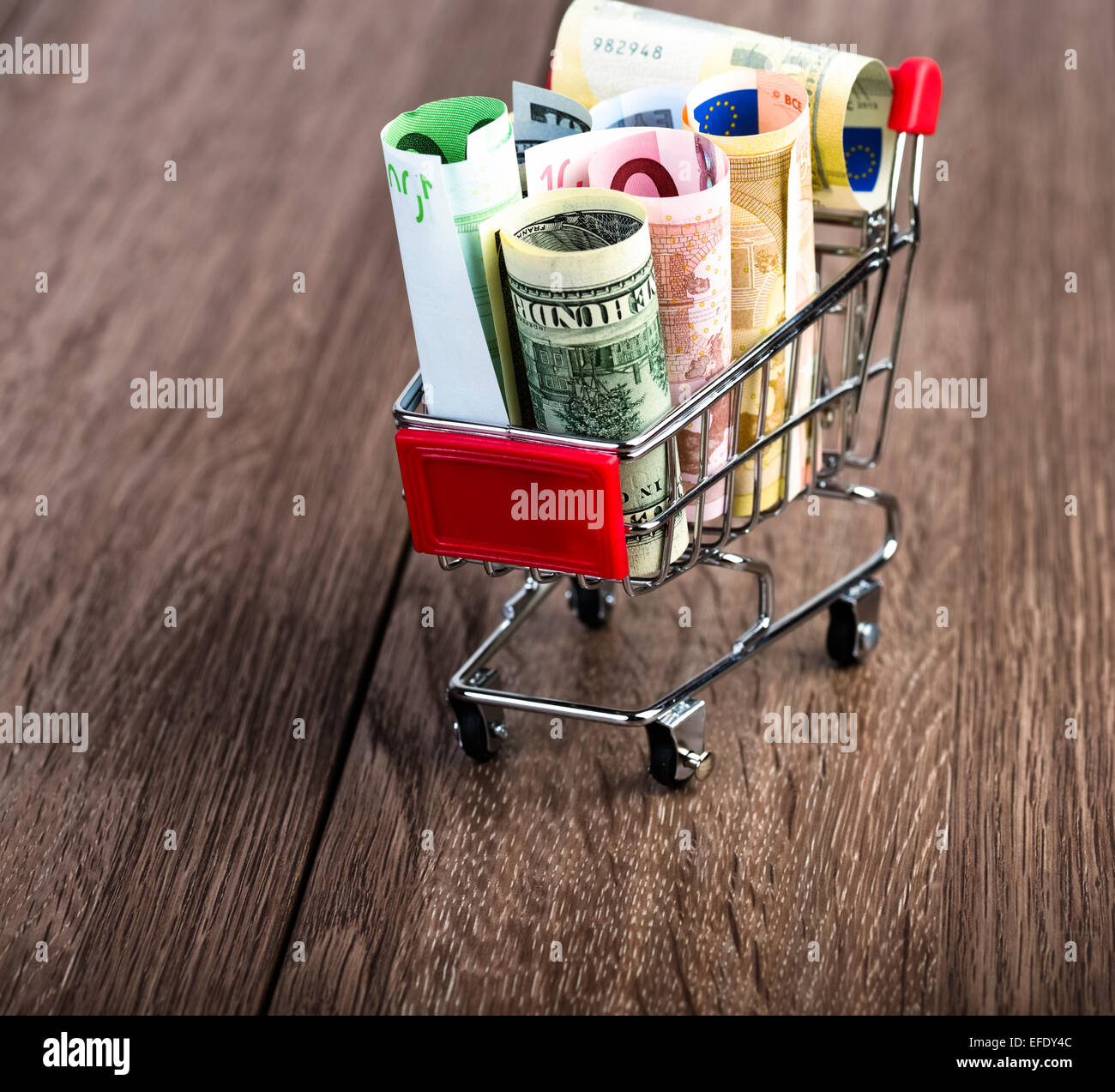 Shopping cart full of money (dollar, euro). Multi currency basket ...