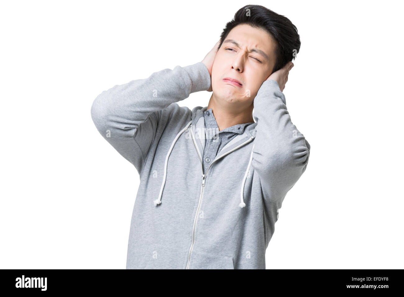 Young man covering ears Stock Photo - Alamy