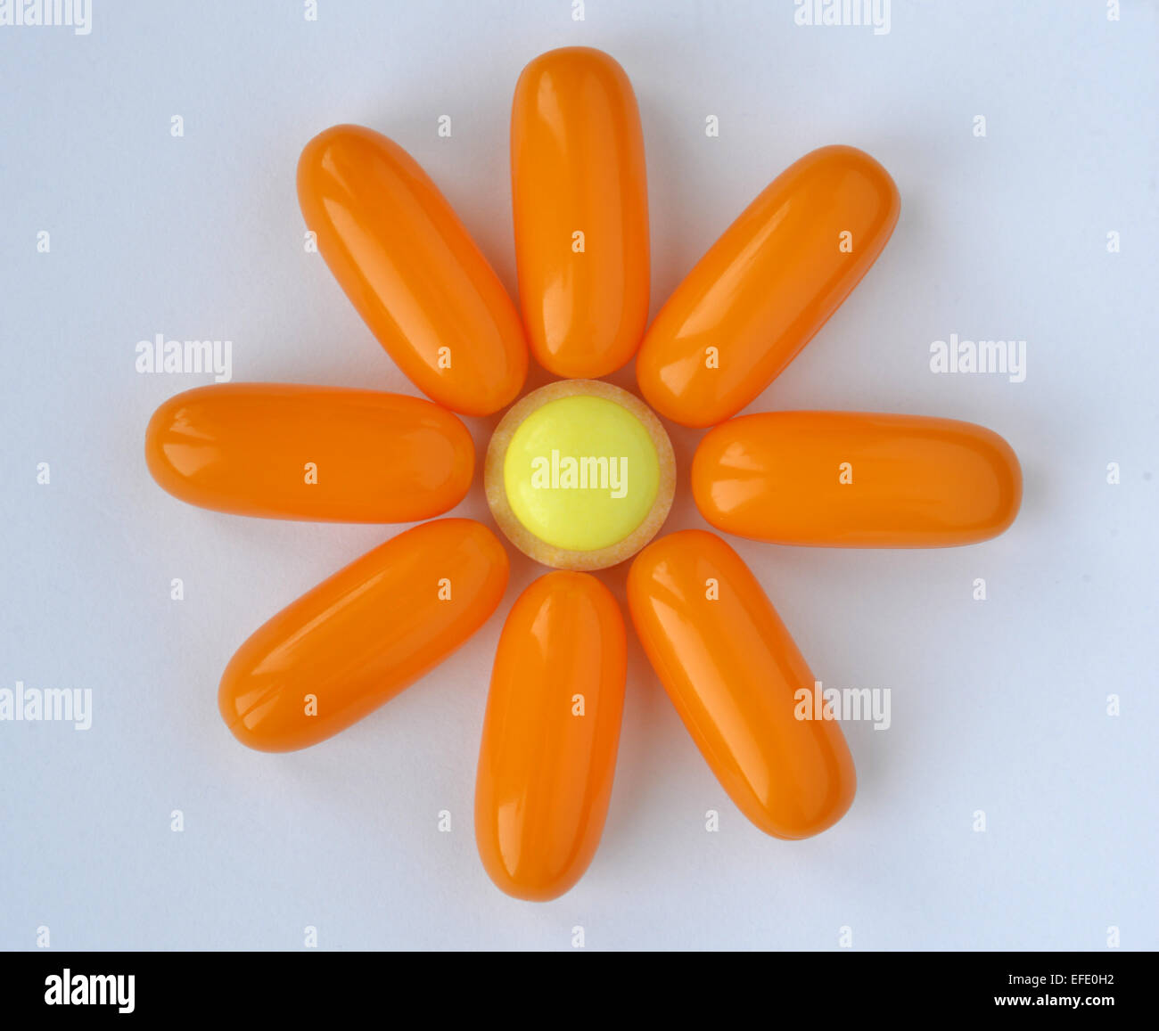 Bright pills are situated on the white background. Composition "Flower ...