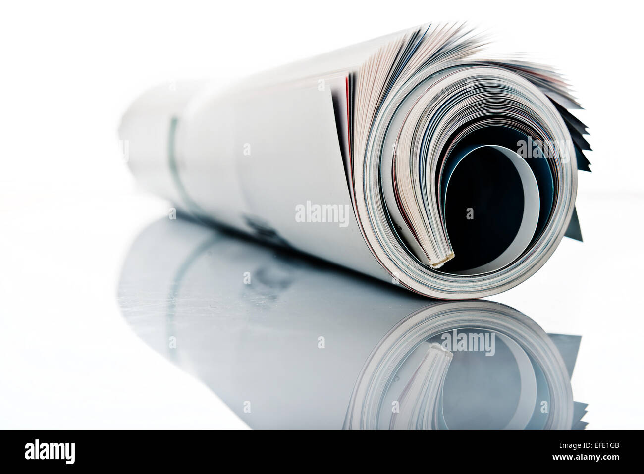 magazine roll on white background Stock Photo - Alamy