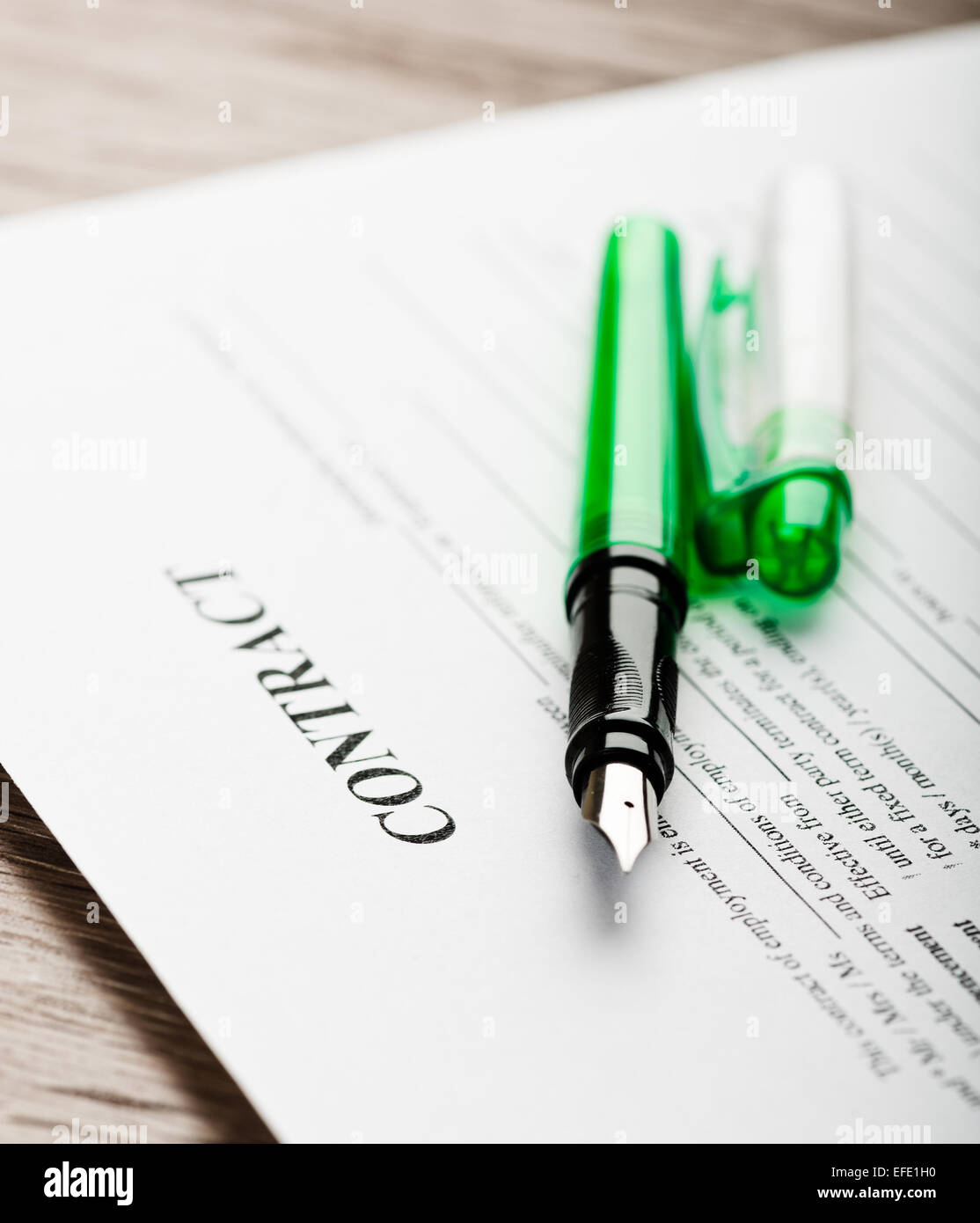 Pen and contract papers on wooden desk Stock Photo - Alamy
