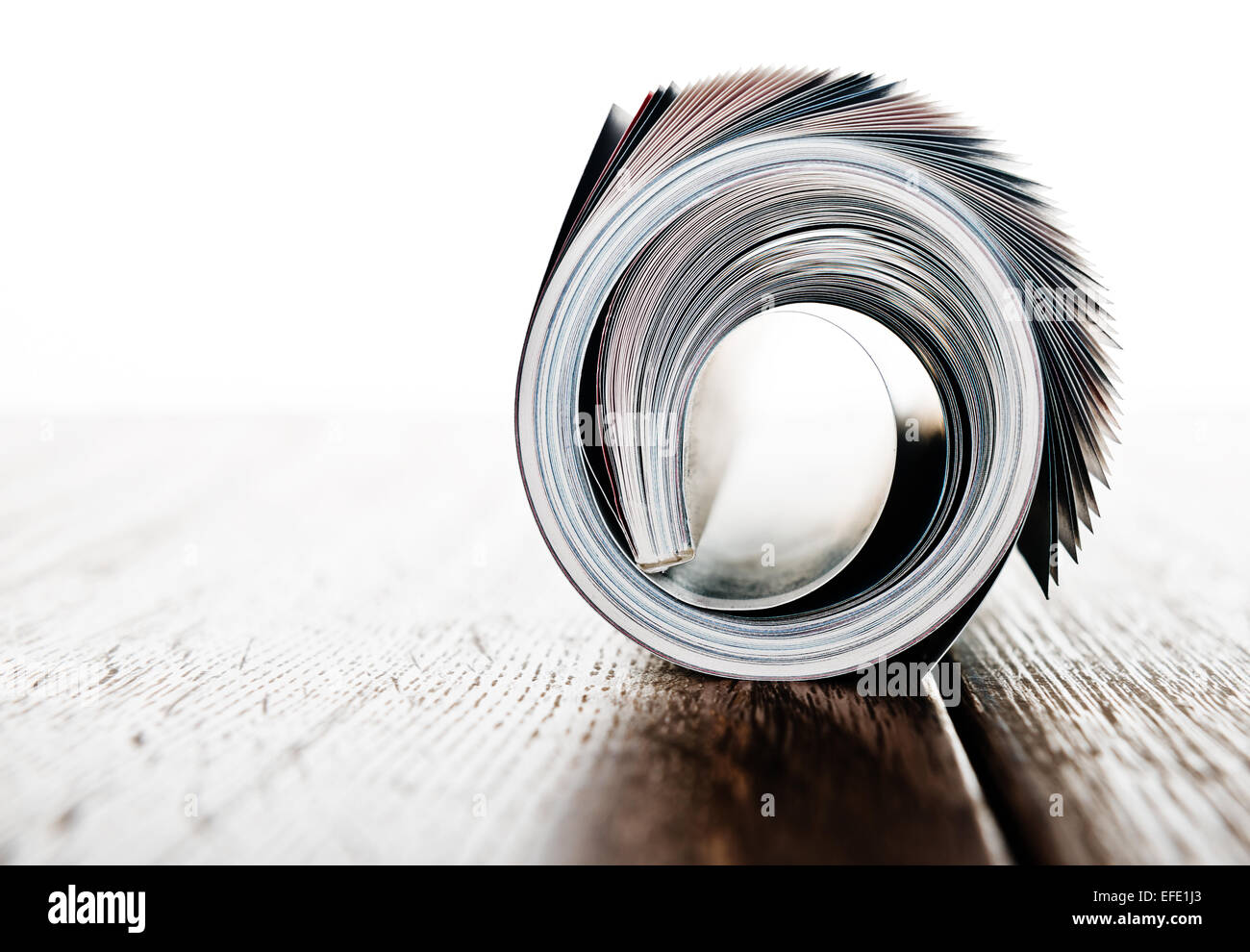 magazine roll on wooden desk Stock Photo - Alamy