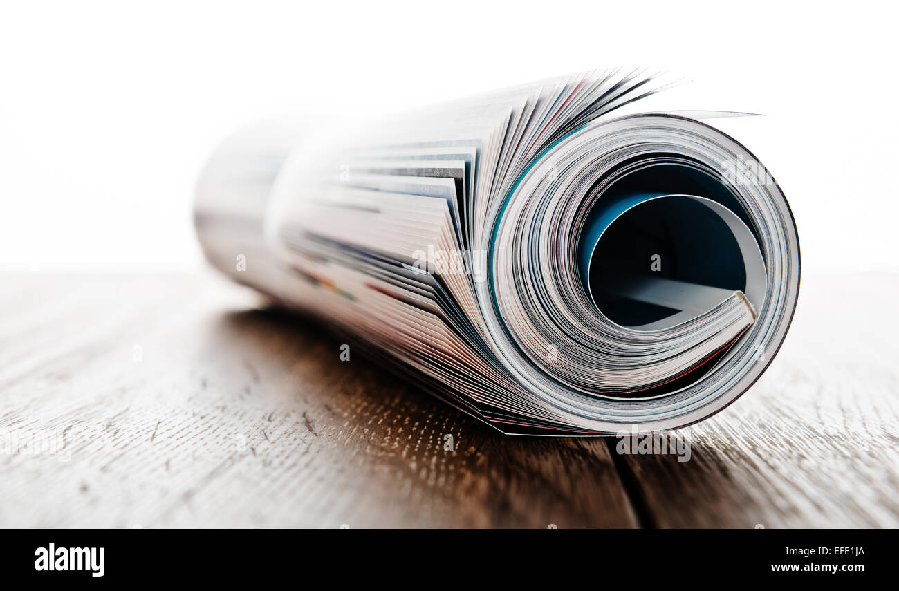 magazine roll on wooden desk Stock Photo - Alamy