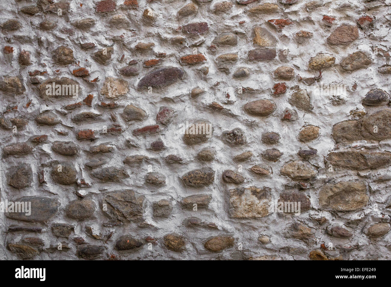 Details of a rustic stone wall and cement Stock Photo - Alamy