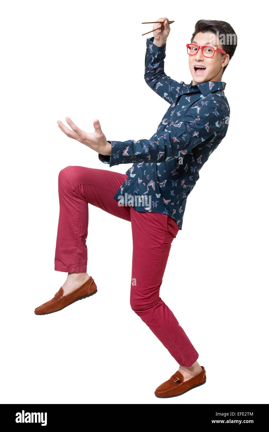 Happy young man using chopsticks Stock Photo - Alamy
