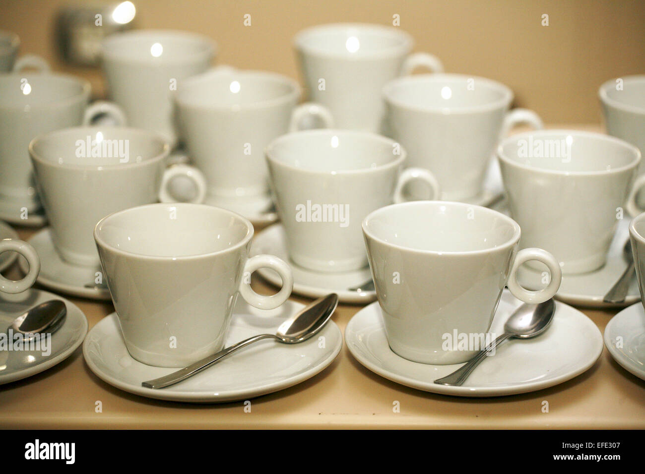 White empty coffee cups and saucers Stock Photo - Alamy