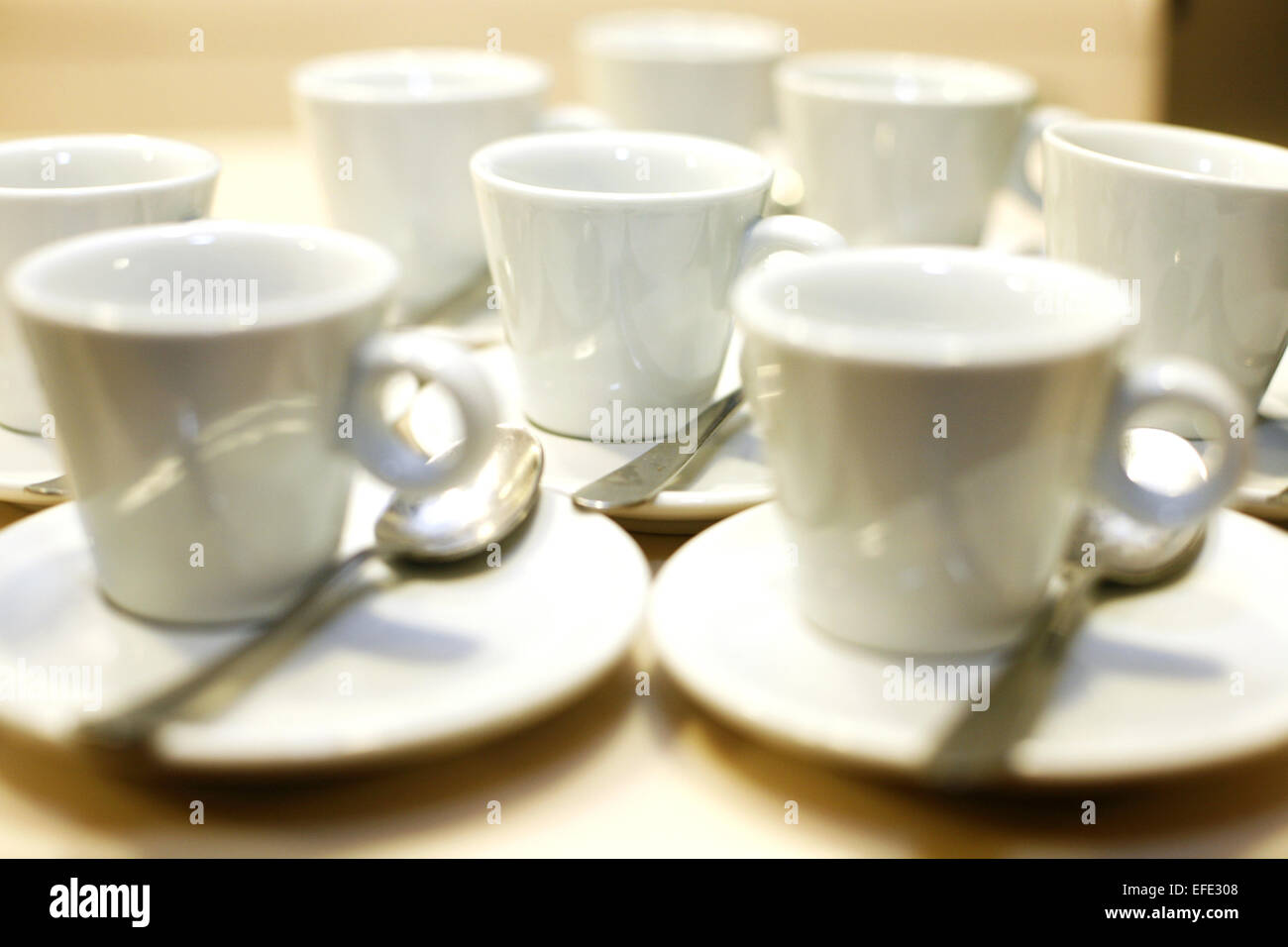White empty coffee cups and saucers Stock Photo - Alamy