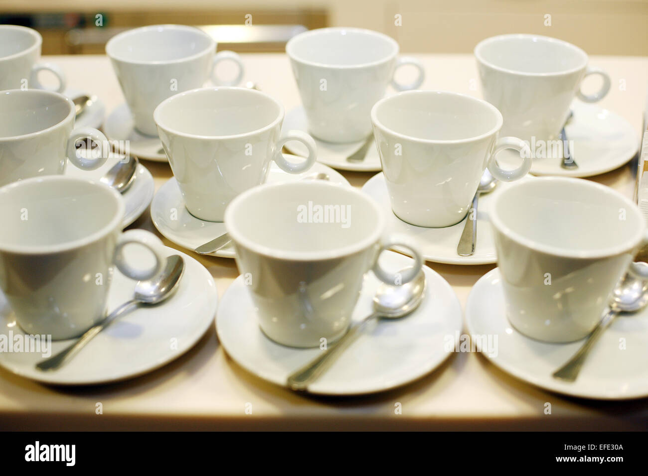 White empty coffee cups and saucers Stock Photo - Alamy