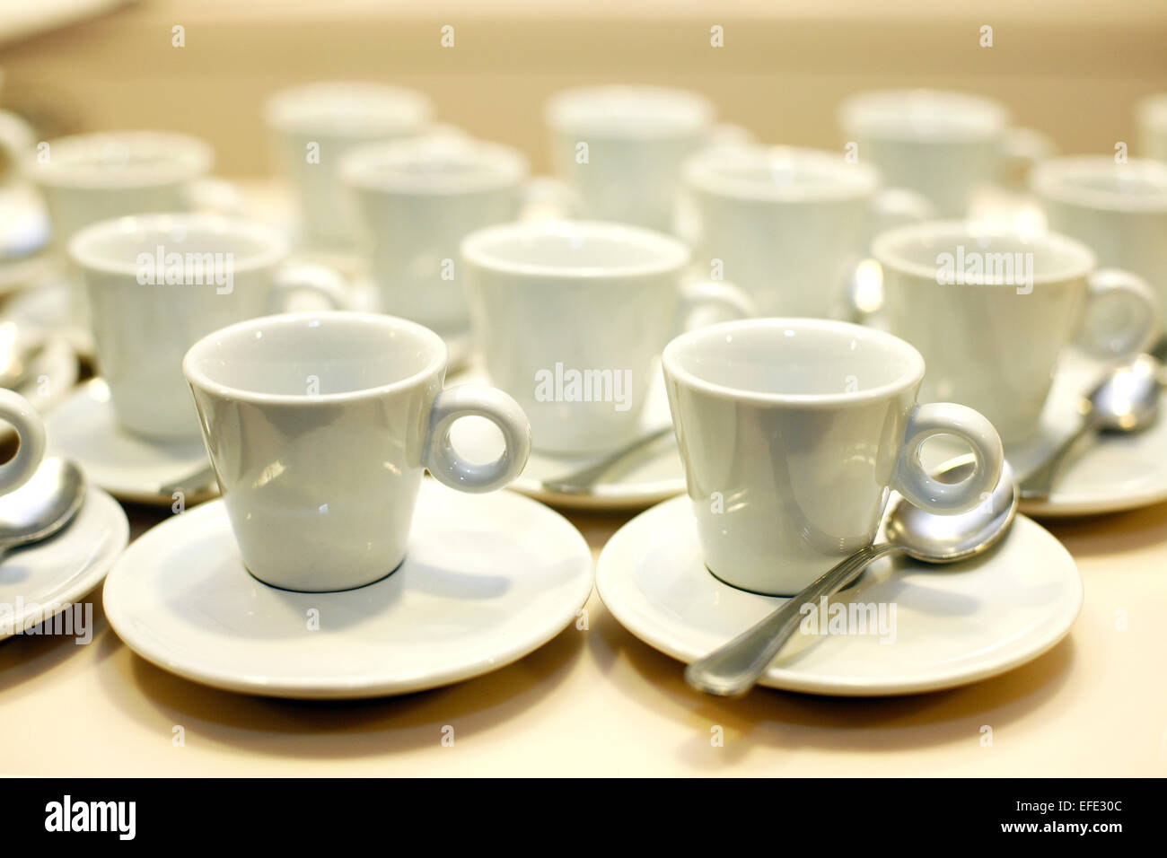 White empty coffee cups and saucers Stock Photo - Alamy