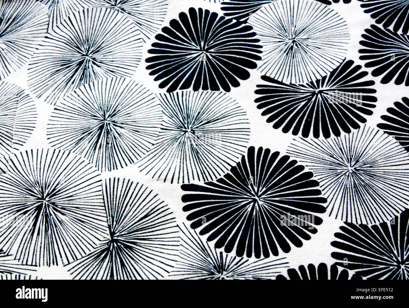 Abstract background of repeating circular flower pattern in black and ...
