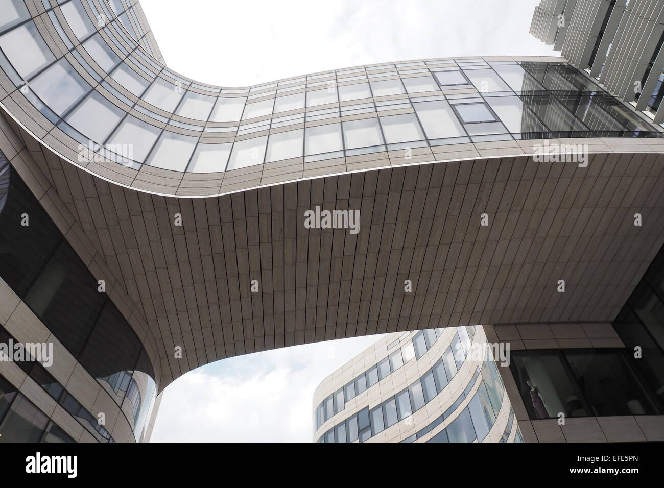 Two office buildings connected by a covered overpass Stock Photo - Alamy