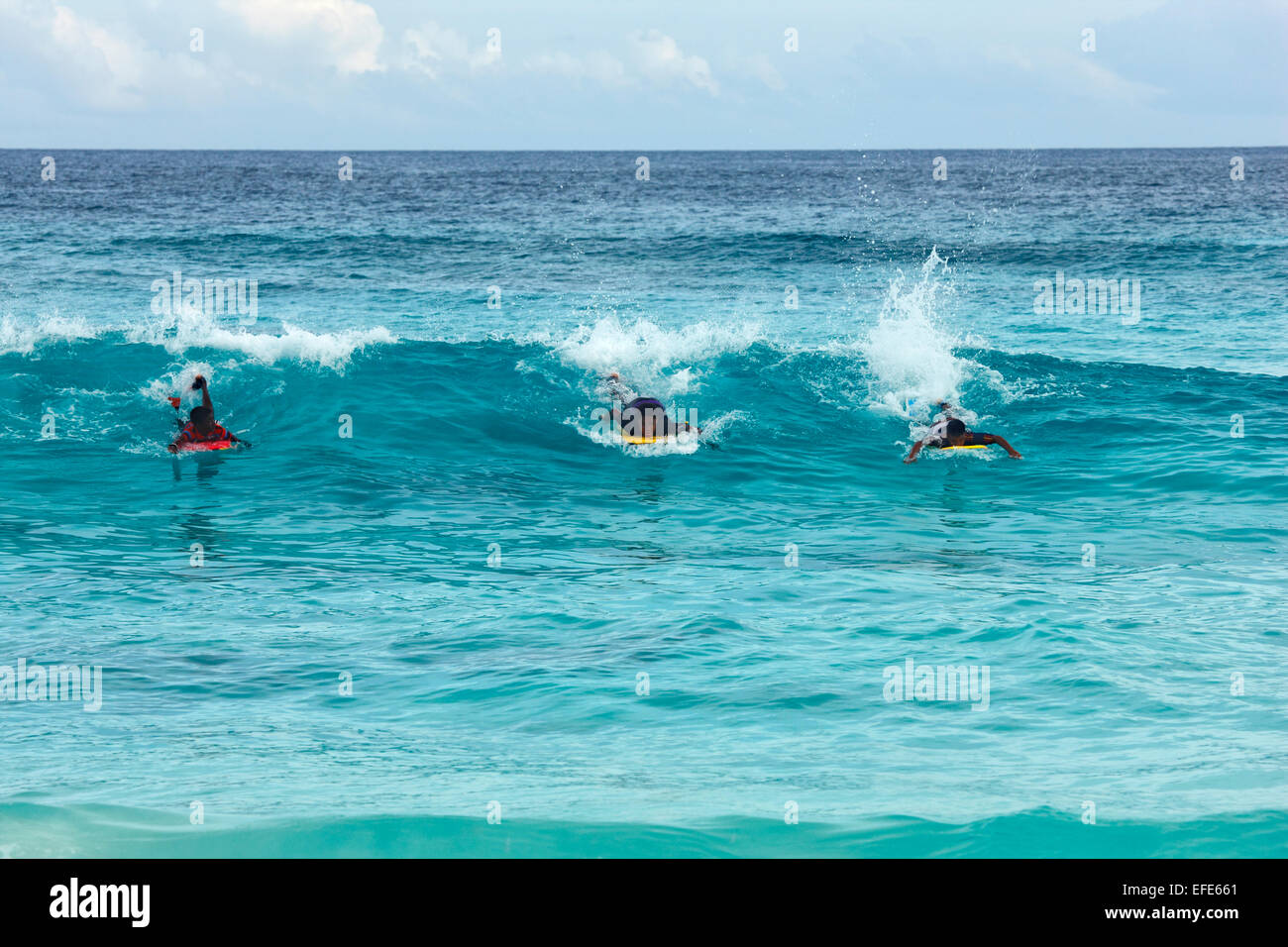 Surfing on the waves, Seychelles Stock Photo - Alamy
