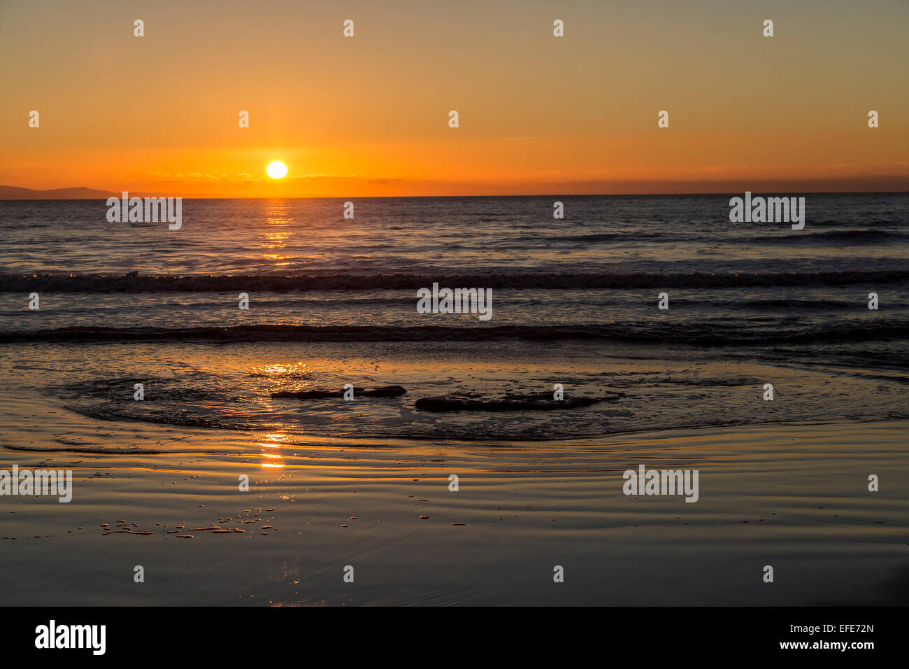 Sunset over waves on beach, Southerndown, Glamorgan Heritage Coast ...