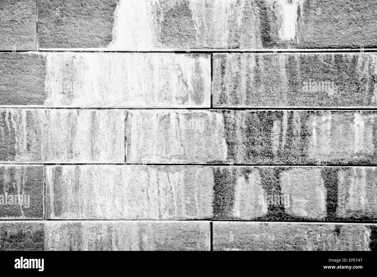 Limescale build up on a brick wall Stock Photo - Alamy