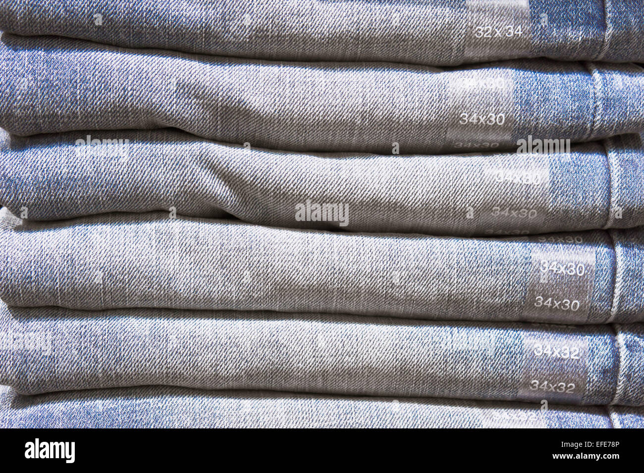 Pile of folded denim trousers Stock Photo - Alamy
