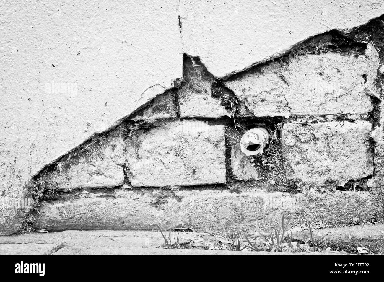 Broken plaster on a wall exposing underlying brickwork Stock Photo - Alamy