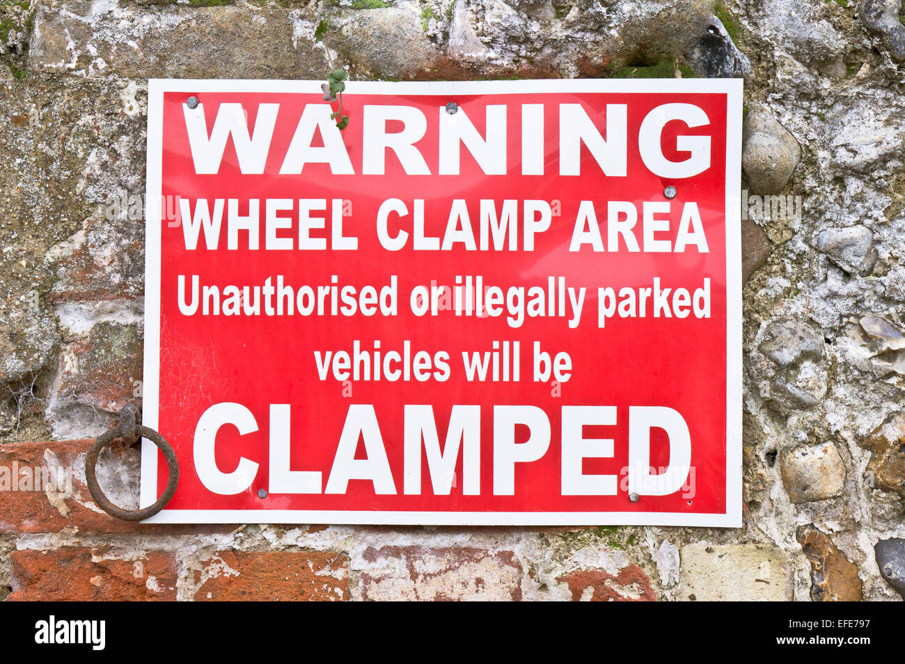 Red warning sign in a car park Stock Photo - Alamy