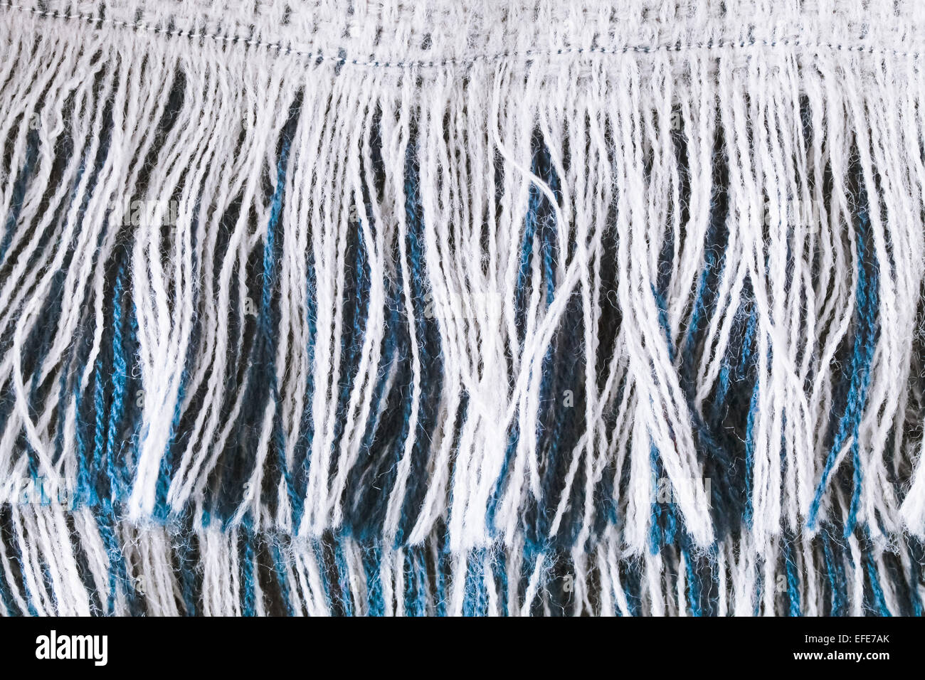 Fringe of a blue and white scarf Stock Photo - Alamy