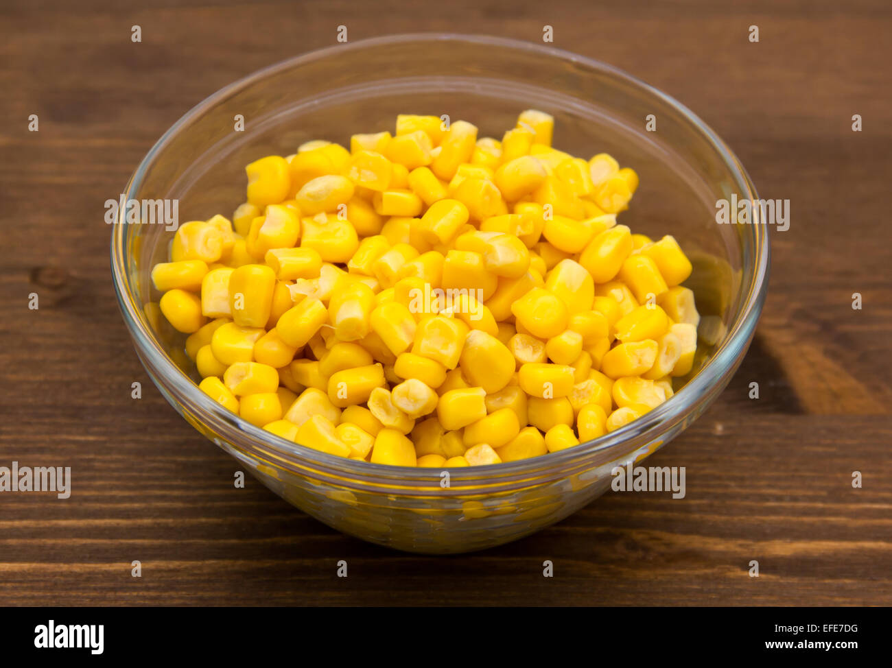 Sweet corn on glass bowl on wooden table Stock Photo - Alamy