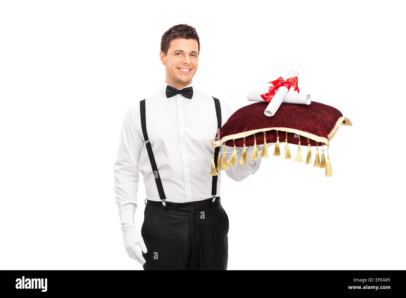 Butler holding a red pillow with two University diplomas isolated on ...