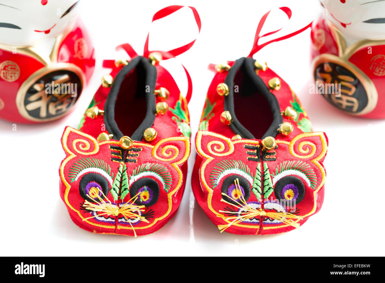 Tiger shoes and Chinese dolls Stock Photo - Alamy