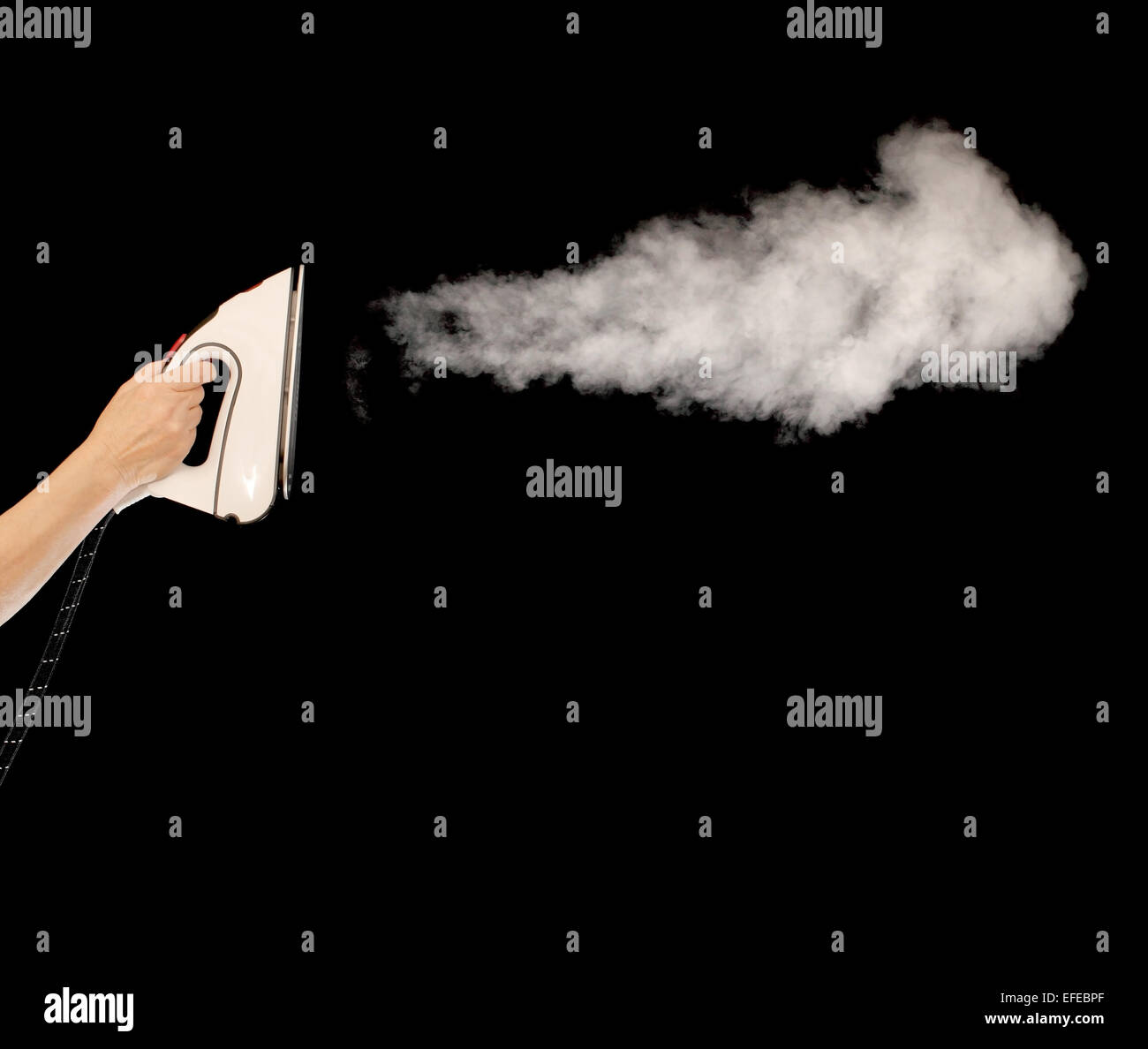 A womans hands holds a steam iron while steam is being emitted Stock ...