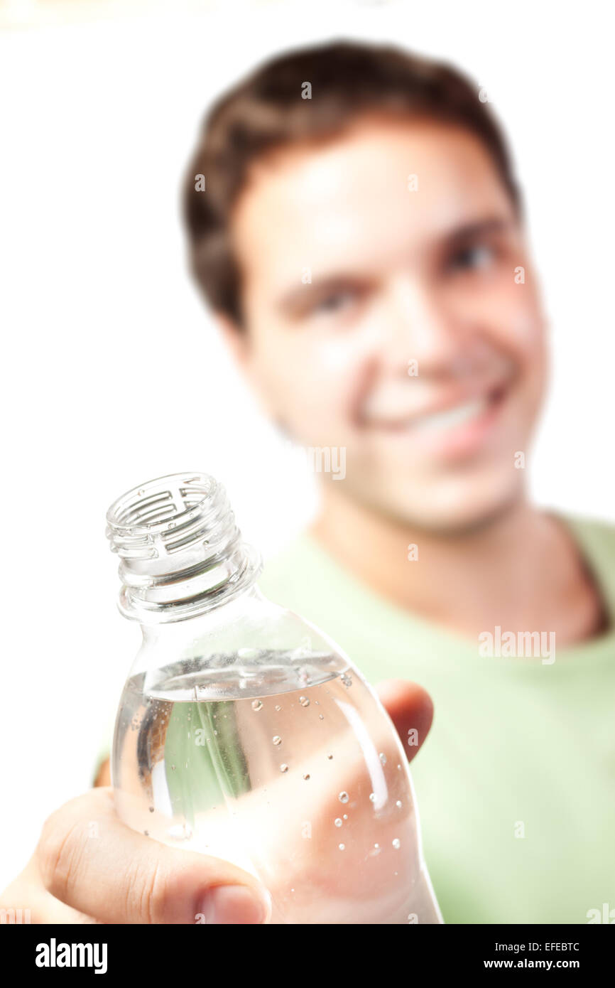 young man holding bottle of water isolated on white background. focus ...