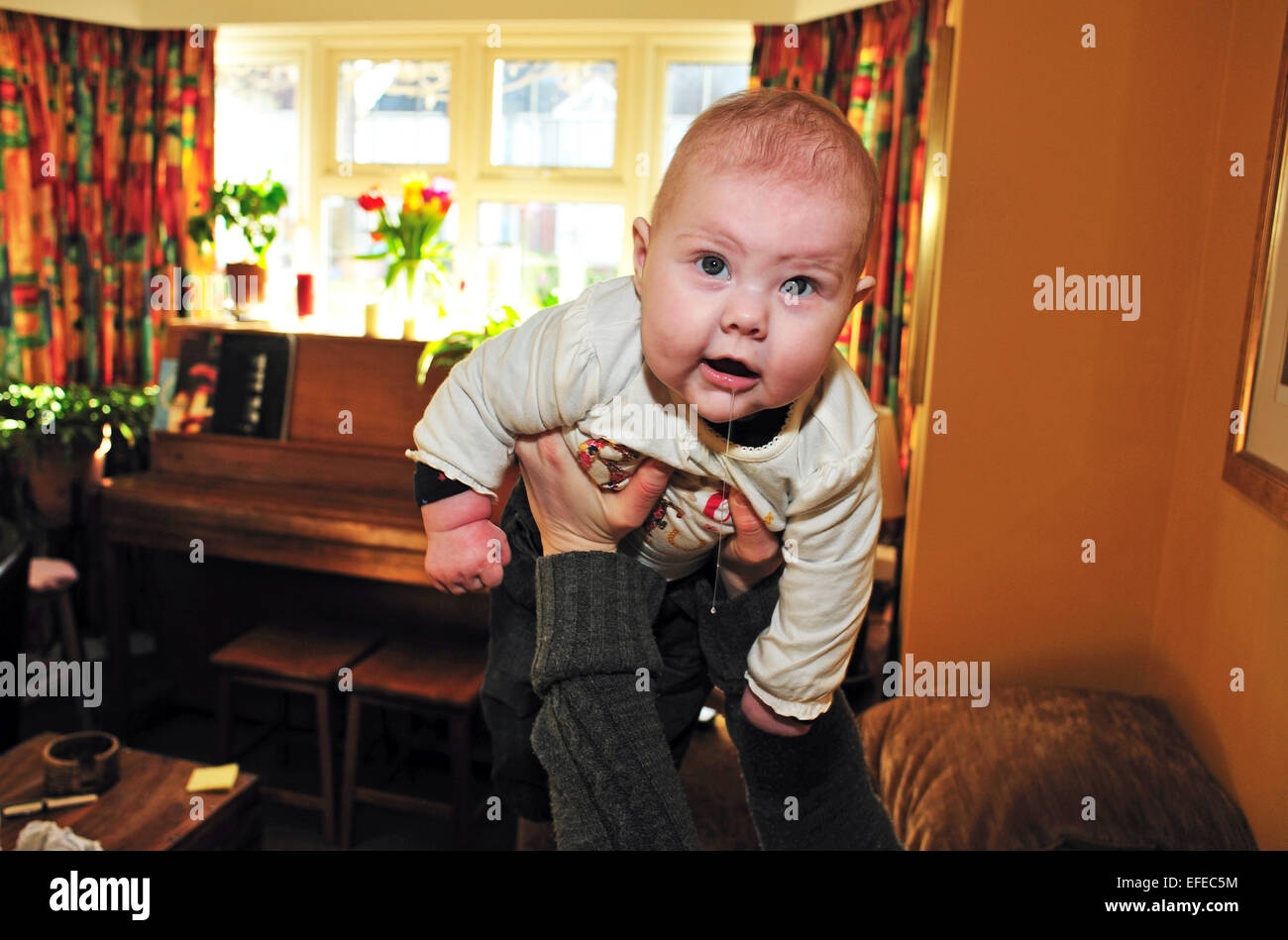 A mother and her four month old baby interacting together through touch ...