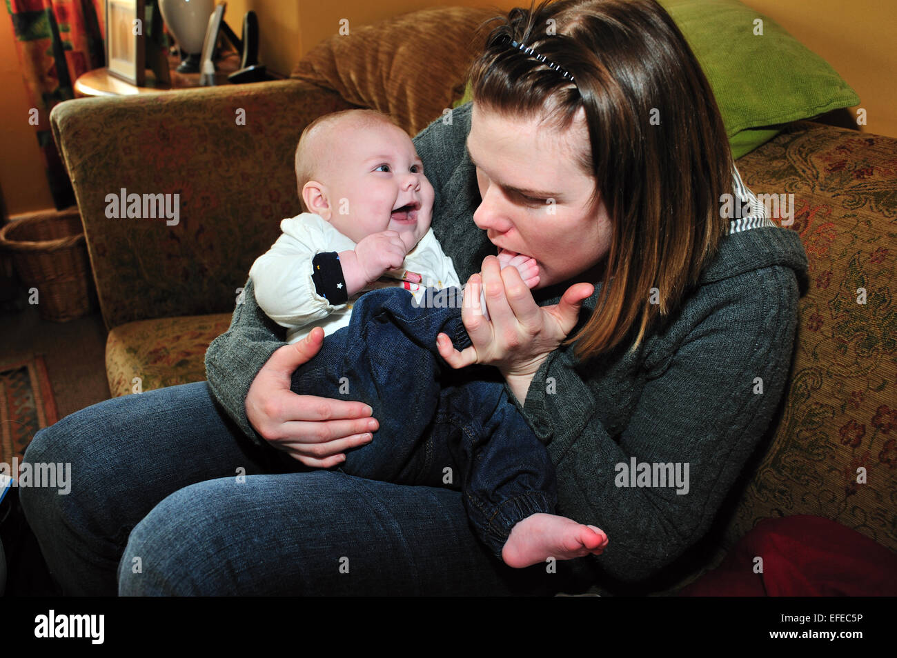 A mother and her four month old baby interacting together through touch ...