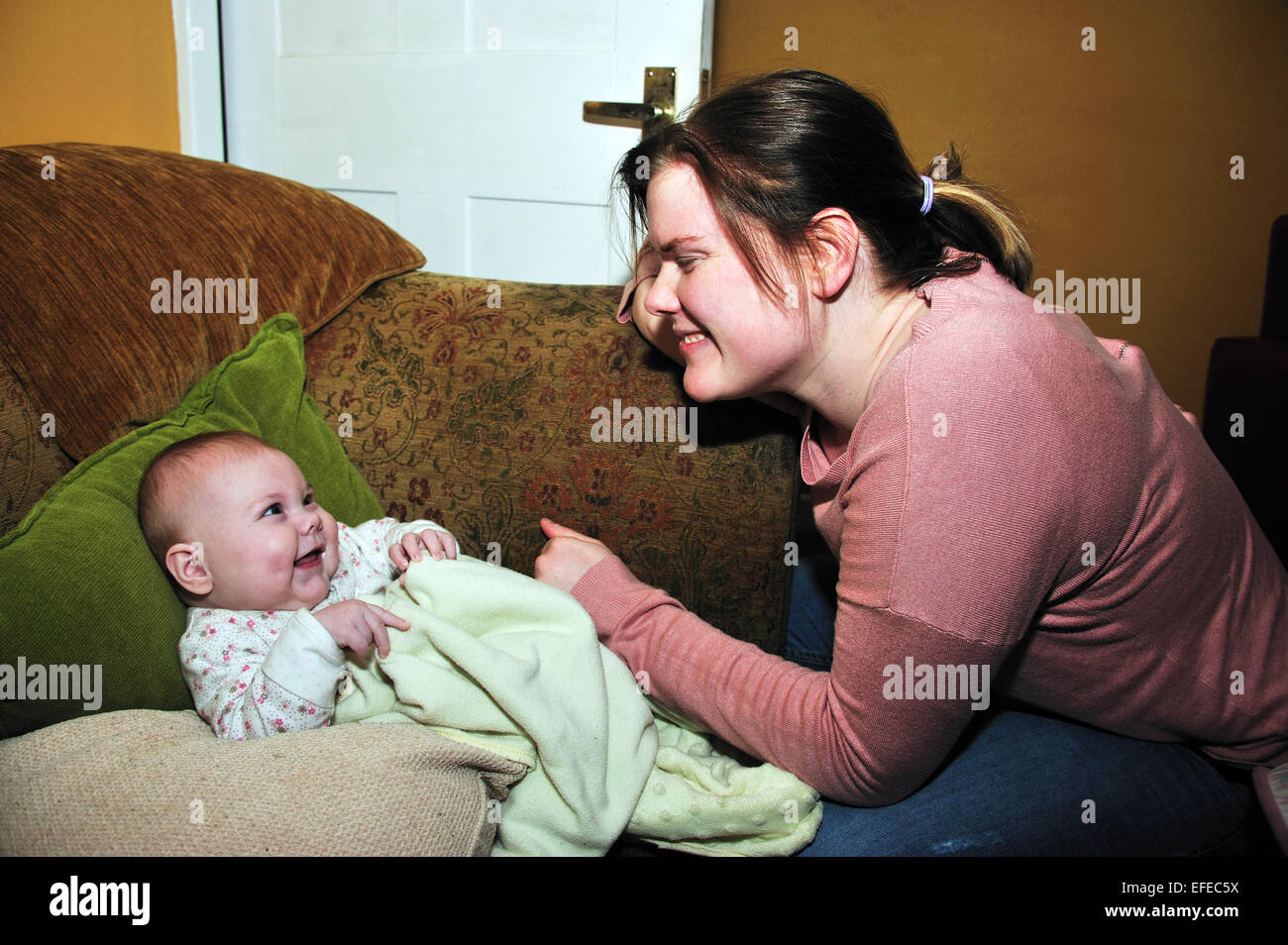 A mother and her four month old baby interacting together through ...