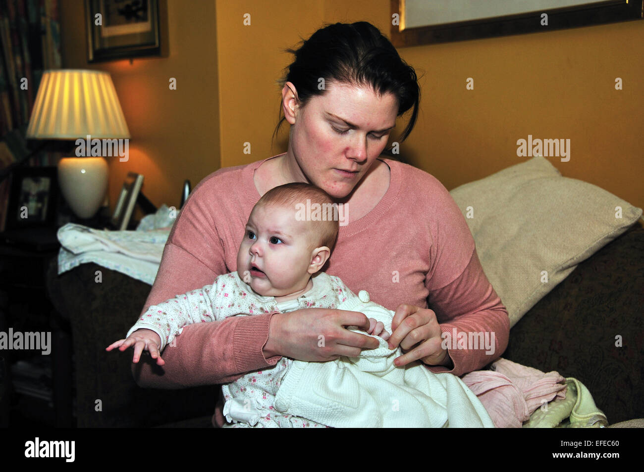 A mother and her four month old baby interacting together through touch ...