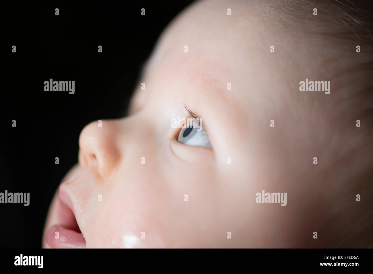 Baby looking into lights Stock Photo - Alamy
