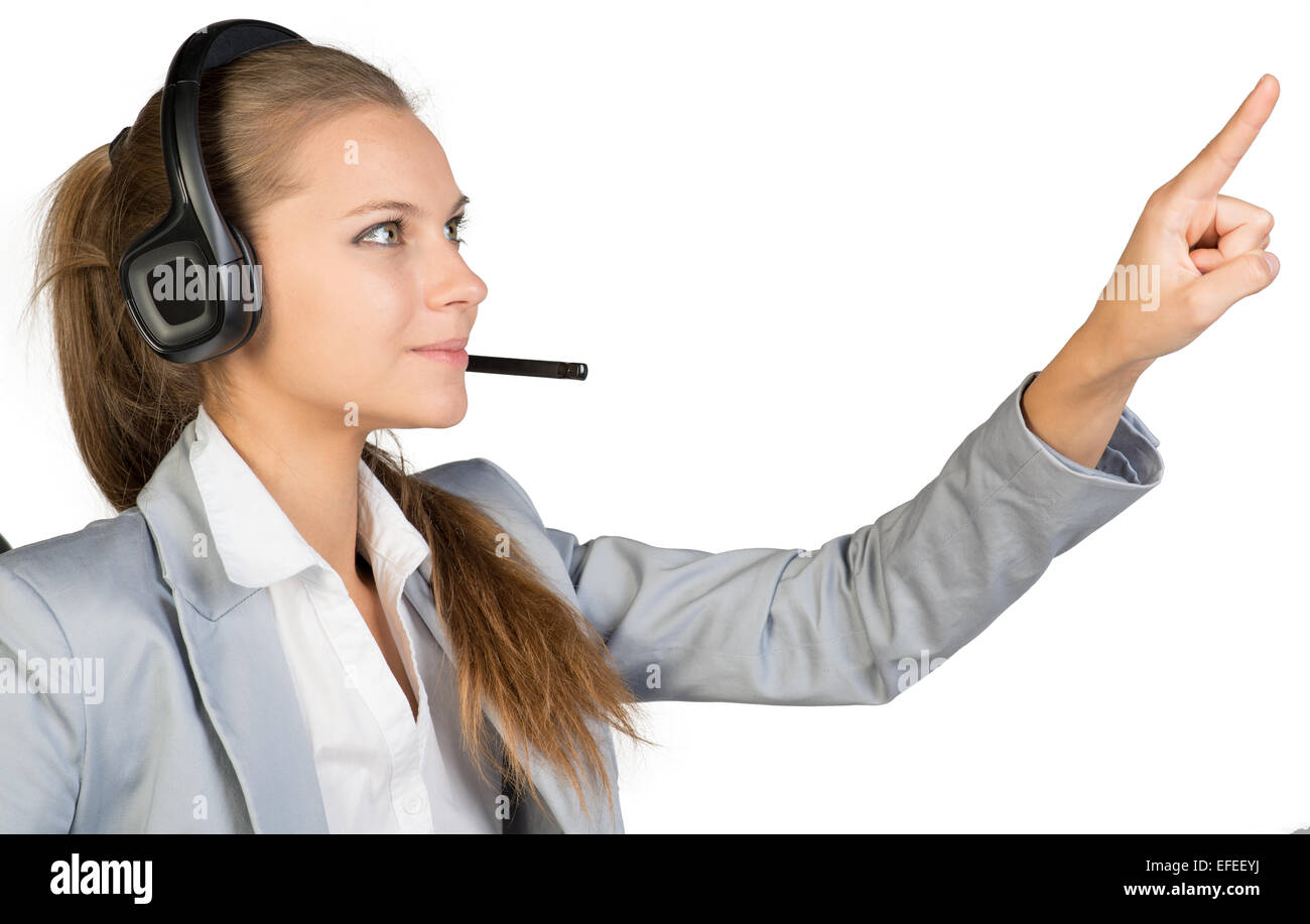 Businesswoman in headset touching or pressing something Stock Photo - Alamy