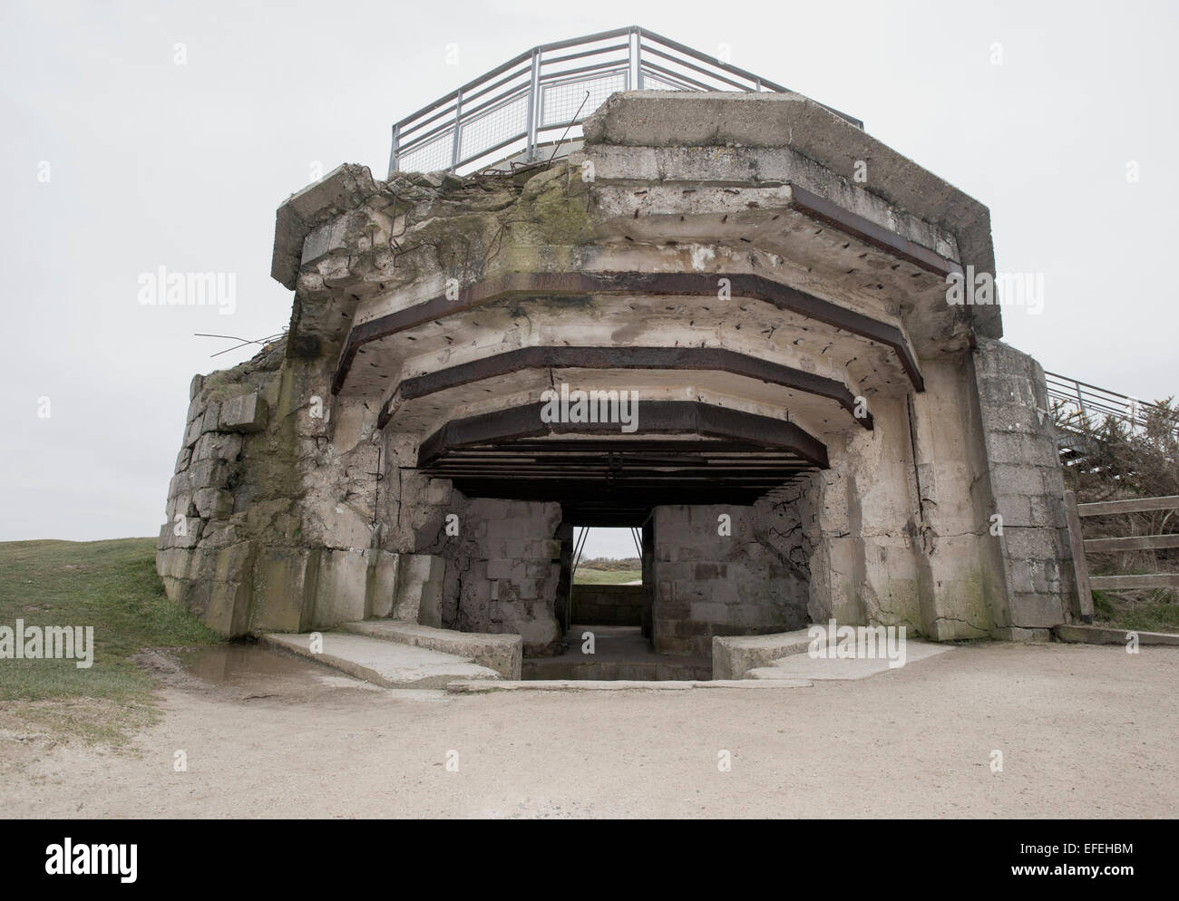 Battered German gun emplacement on the Normandy beach defenses, damaged ...